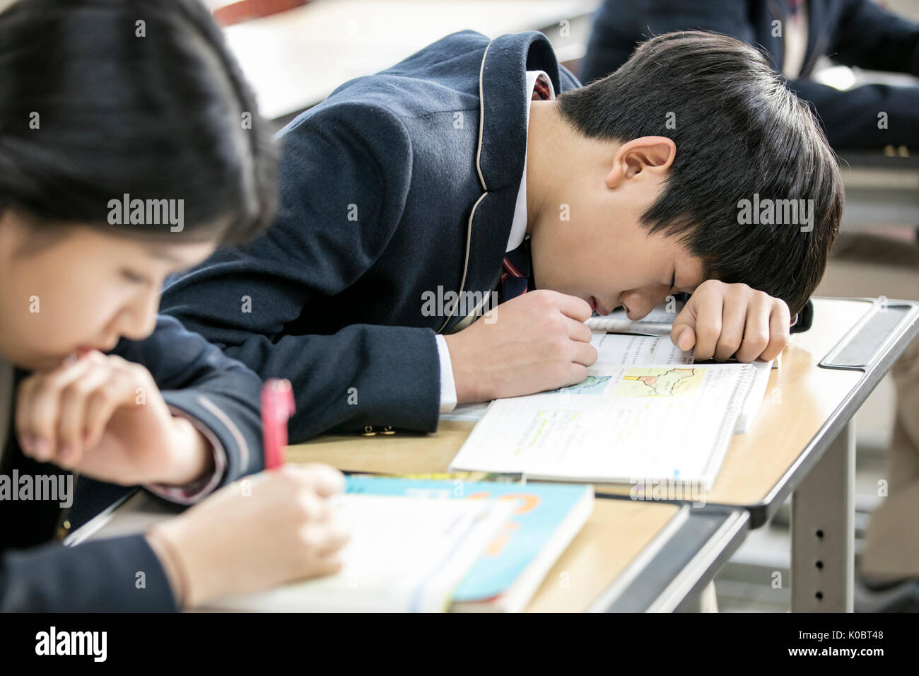 Portrait of tired school boy sleeping during class Stock Photo - Alamy