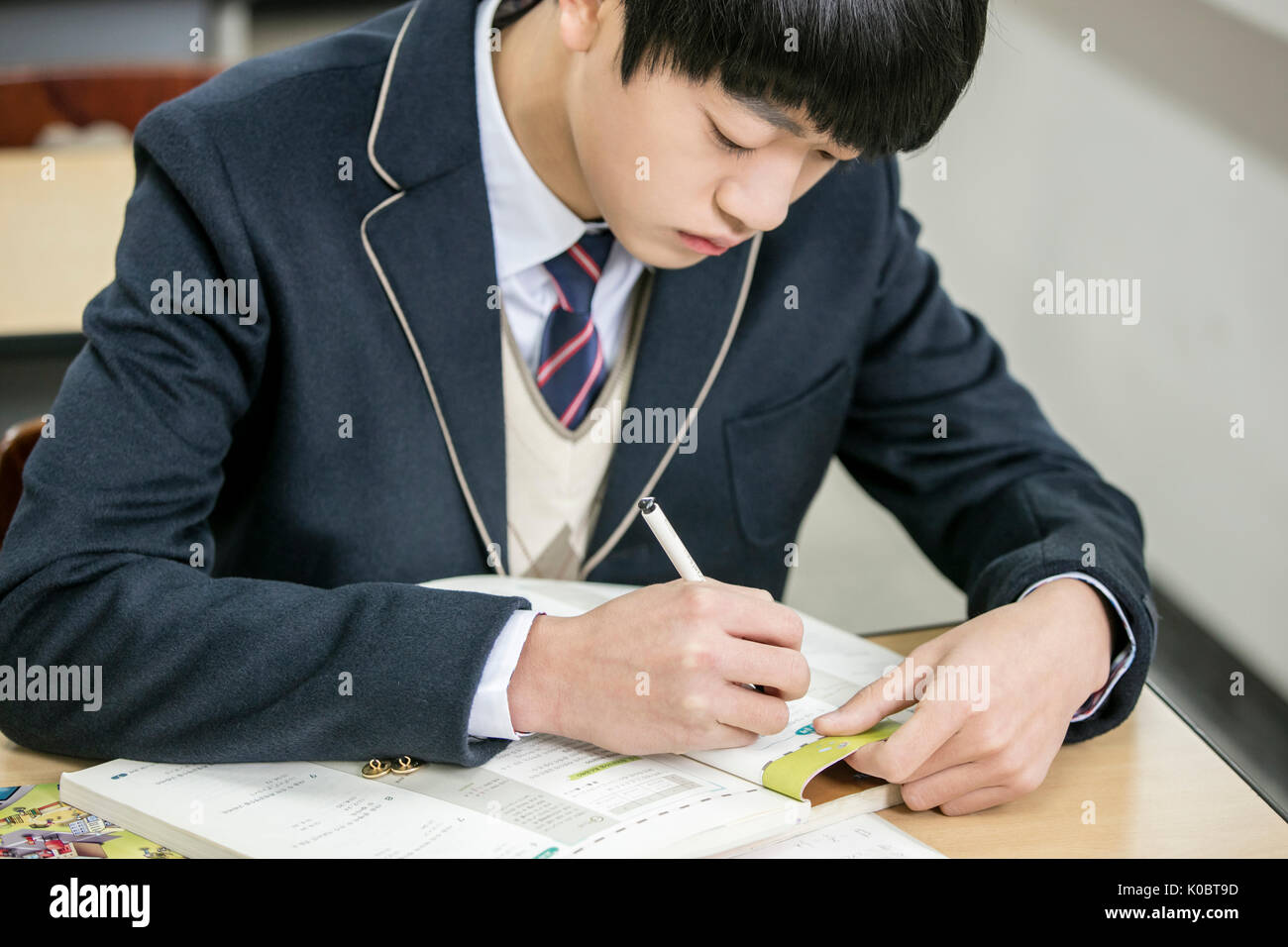 Portrait of school boy concentrating on class Stock Photo - Alamy