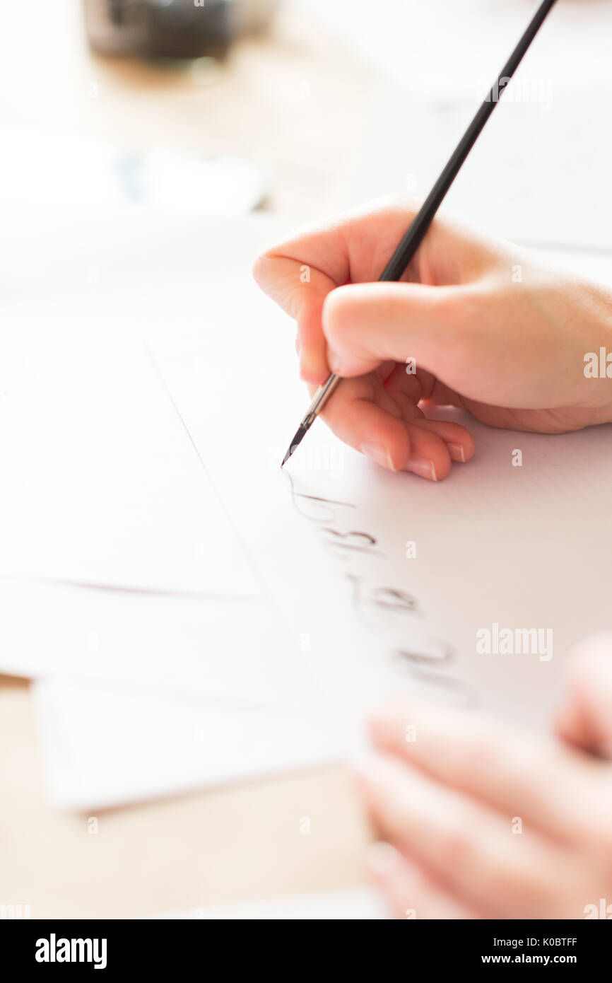 culture, calligraphy, fine art concept. close up of young hands of ...