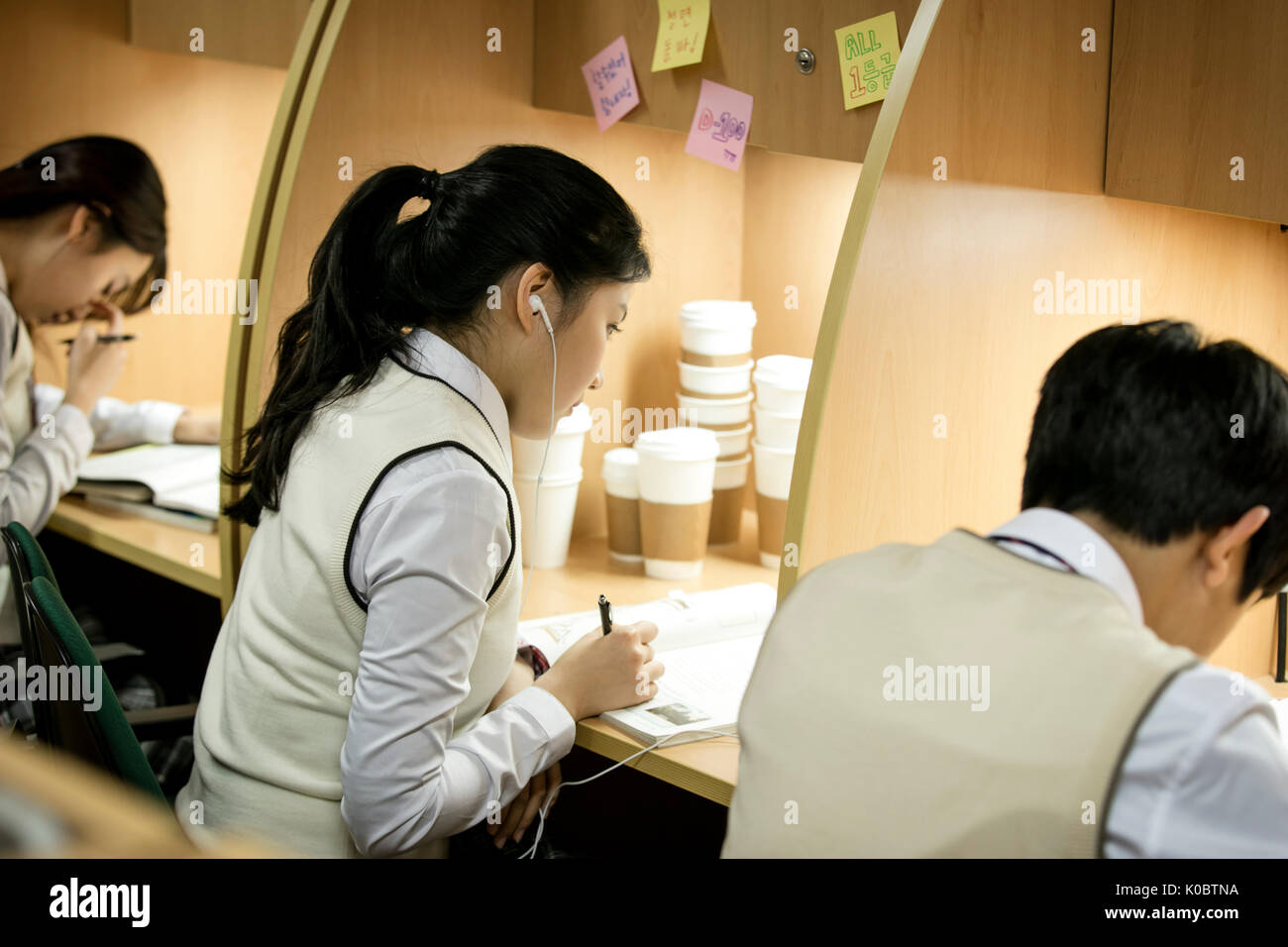 Side view of school students studying hard in reading room Stock Photo ...