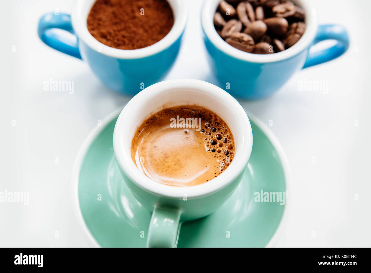 Three cups of coffee: ground coffee (powder), coffee beans and freshly ...