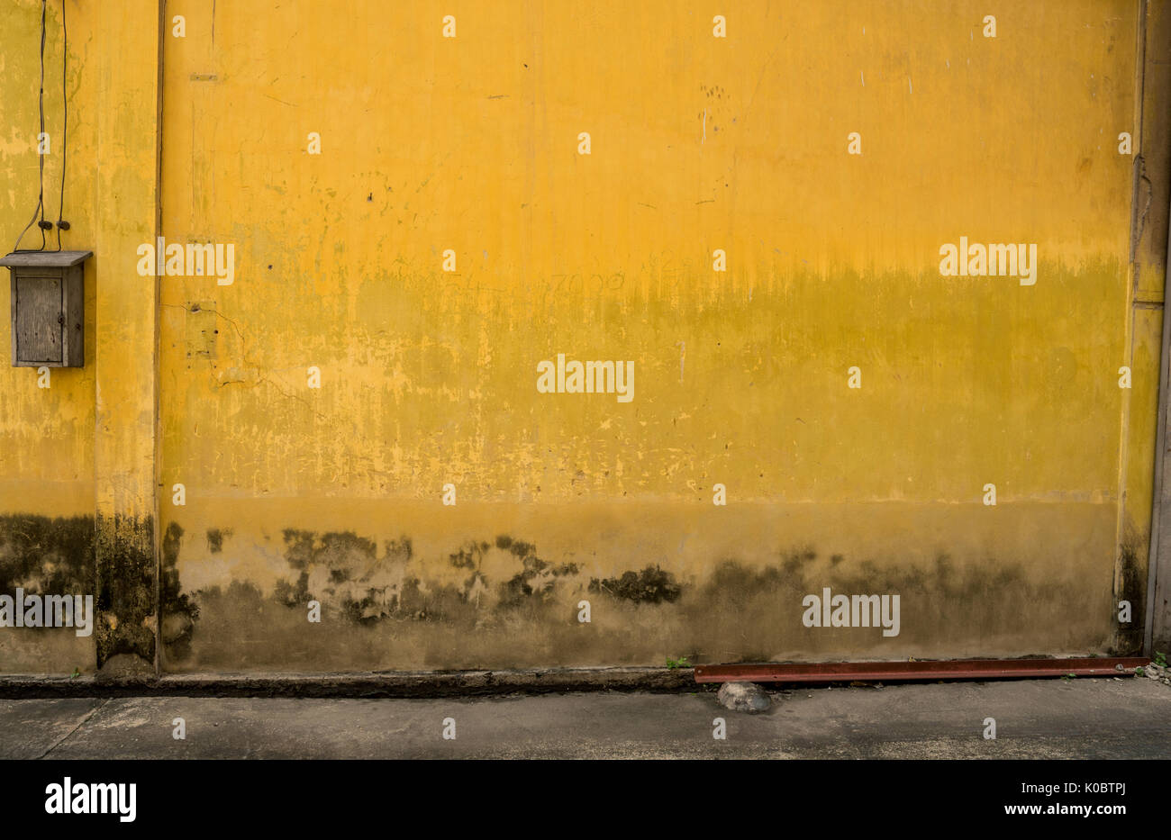 Texture of old yellow vintage wall of industrial factory with electric ...