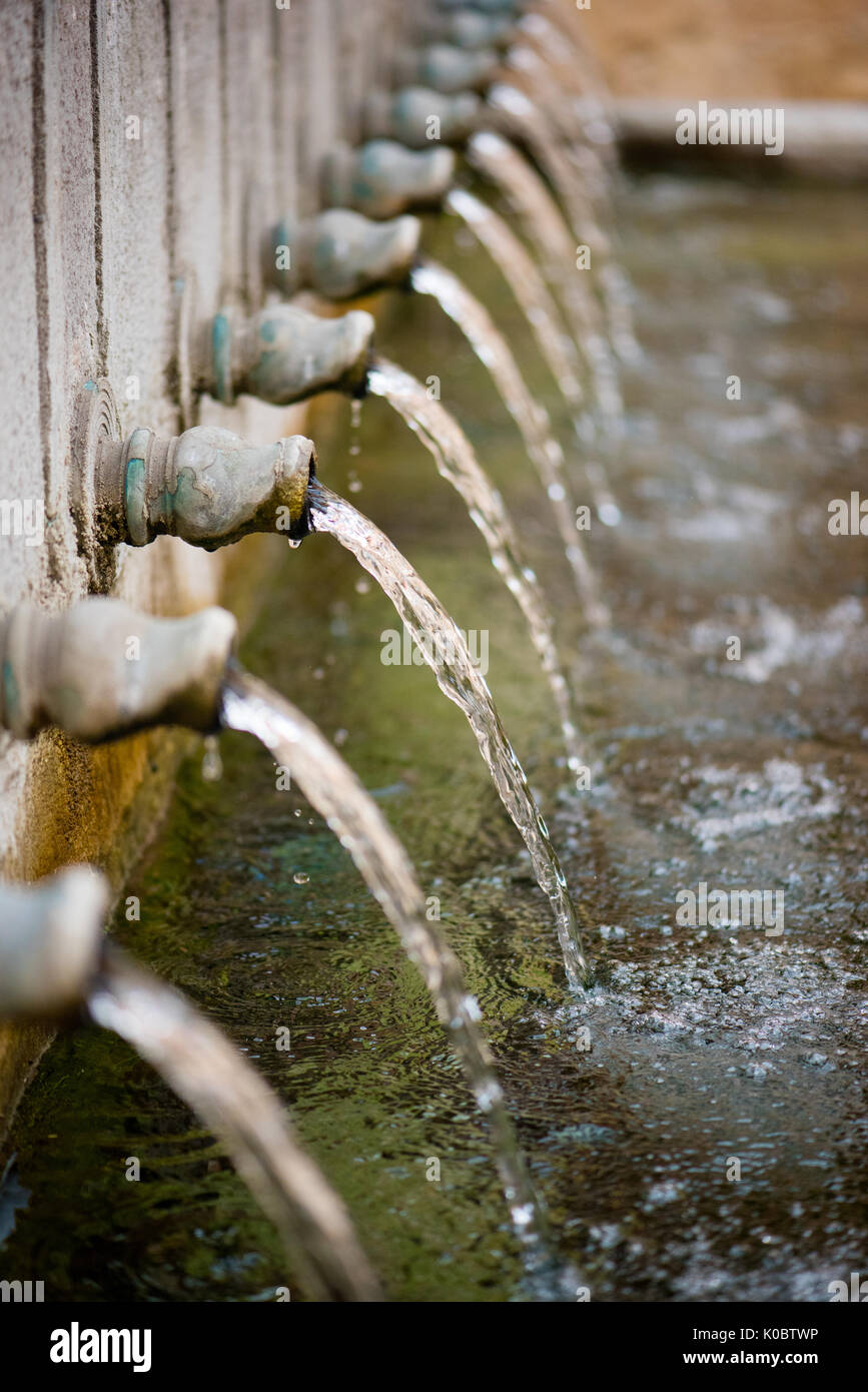 Water from a pipe of vases of pure sources Stock Photo - Alamy