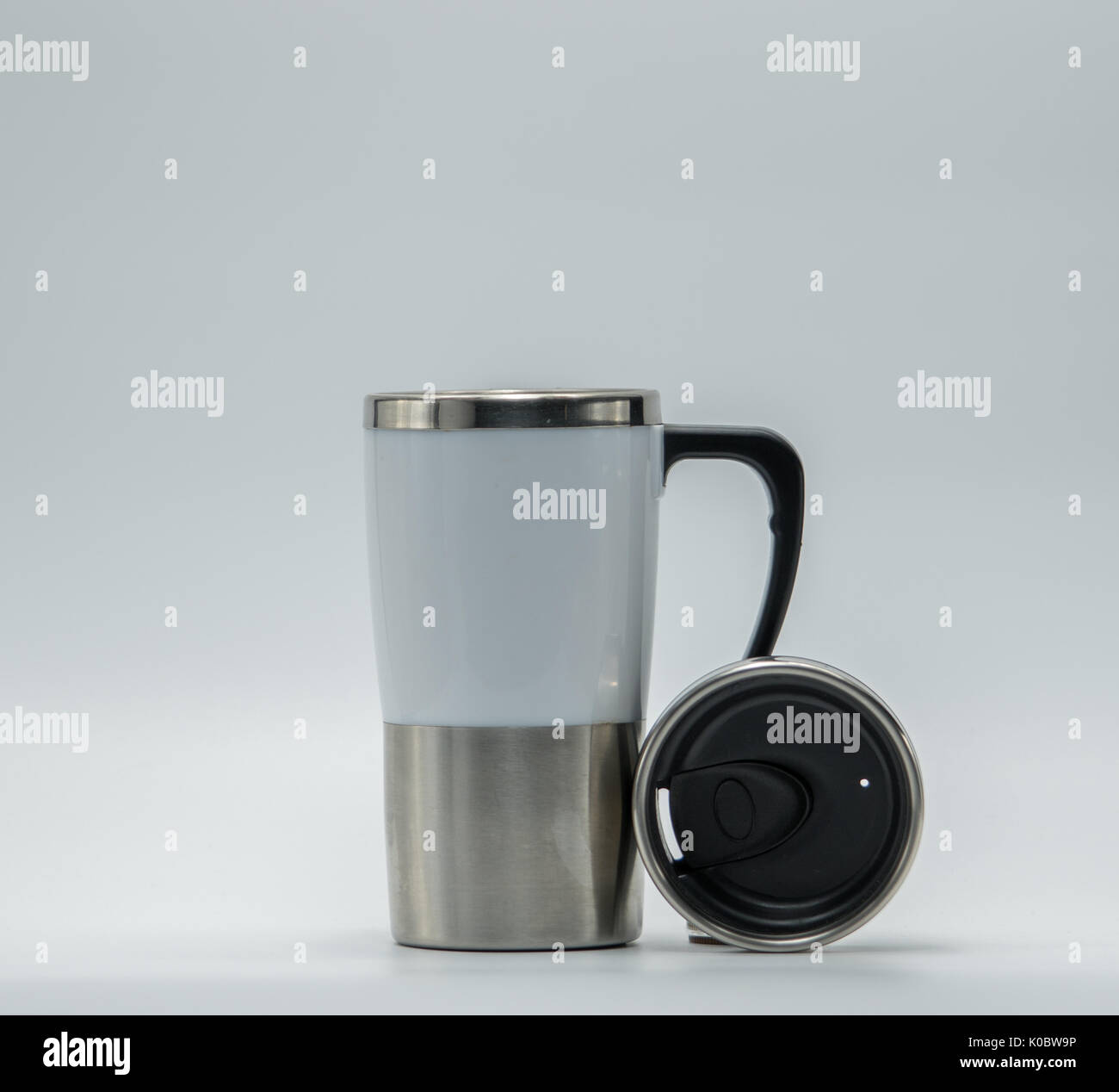 Modern thermos bottle with opened lid isolated on white background ...