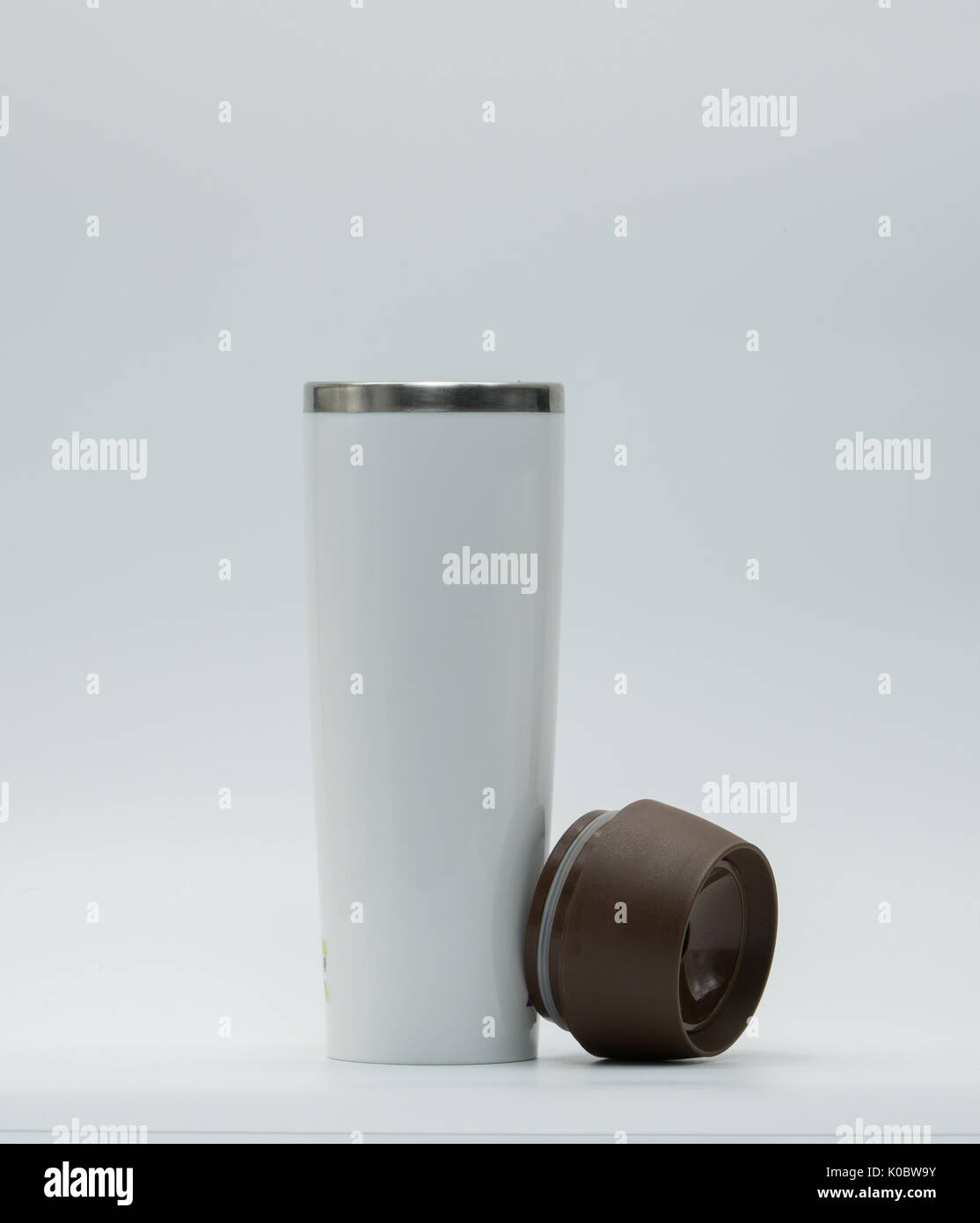 Modern thermos bottle with opened lid isolated on white background ...