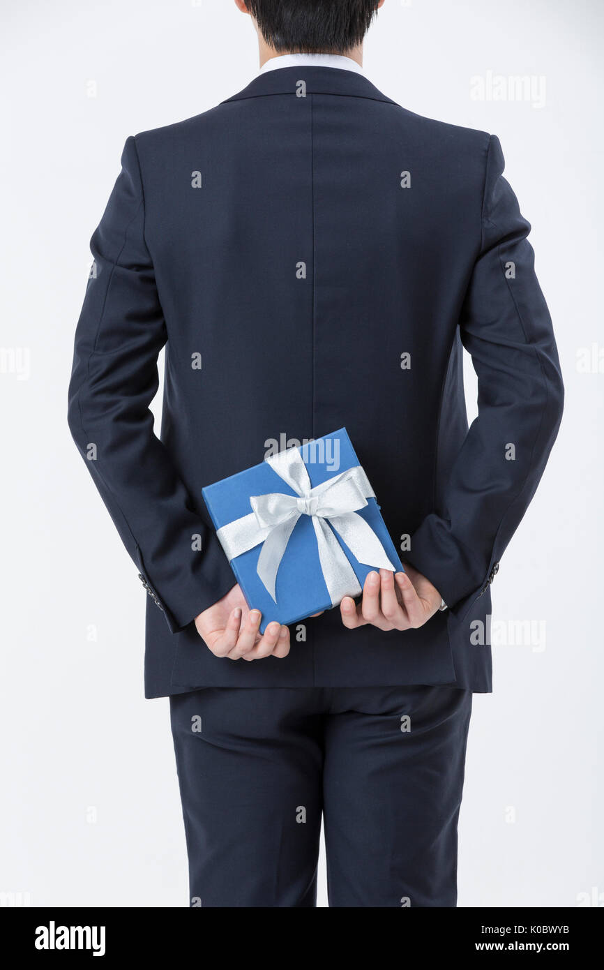 Back businessman holding present hi-res stock photography and images ...