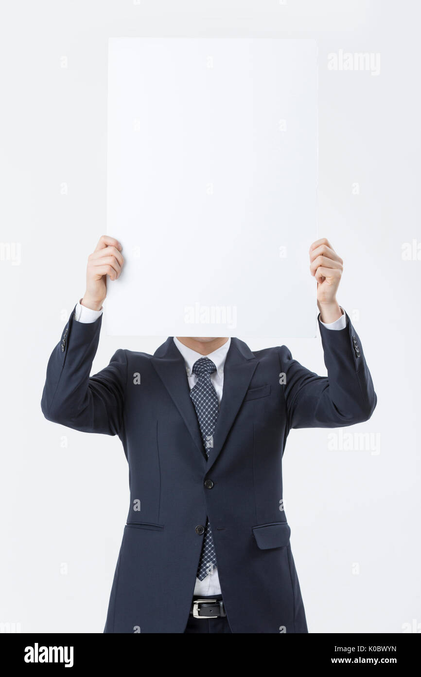 Businessman covering his face with placard Stock Photo - Alamy