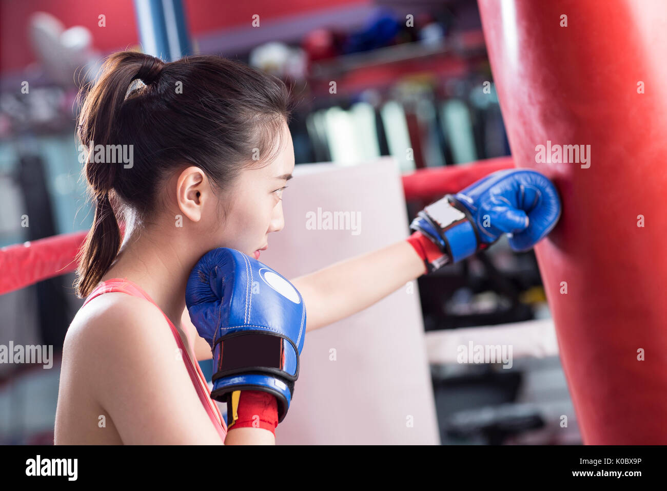 Side view portrait of young female boxer exercising Stock Photo - Alamy