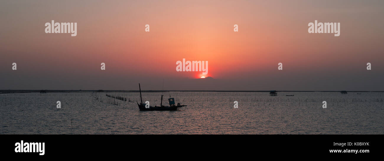 Beautiful sunset above the sea with ship Stock Photo - Alamy