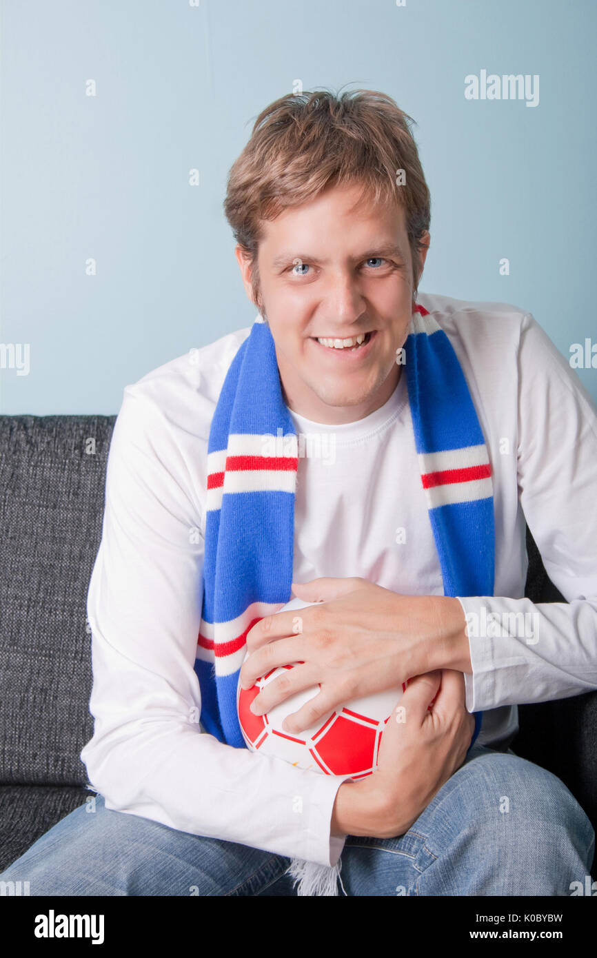 smiling young man supporting his football team Stock Photo - Alamy