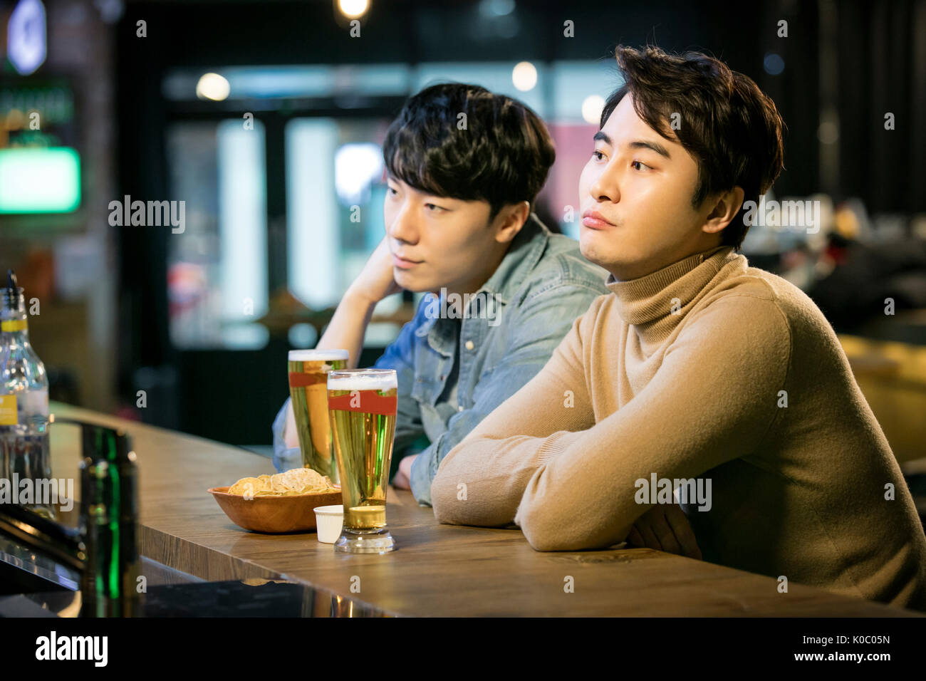 Portrait of two young men at bar Stock Photo - Alamy