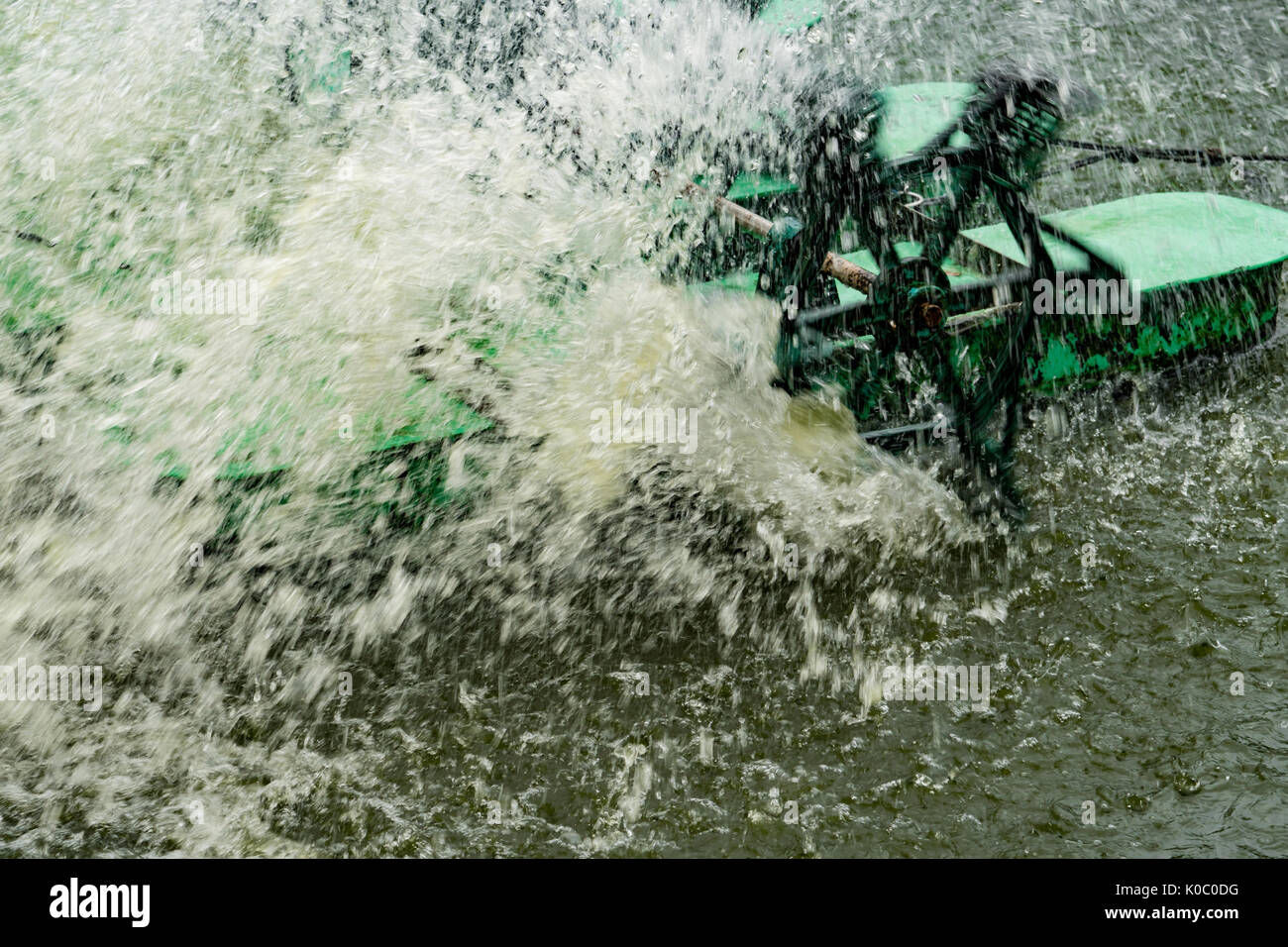 Water turbine is working, water splash around the turbine which hitting ...