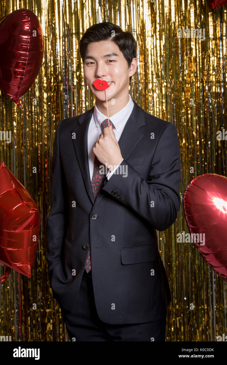 Young smiling man posing at party Stock Photo - Alamy