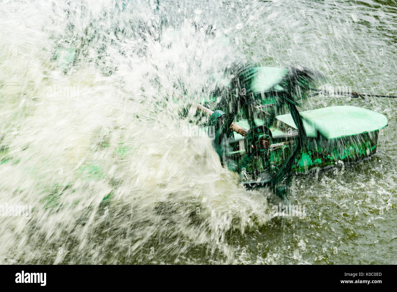 Water turbine is working, water splash around the turbine which hitting ...