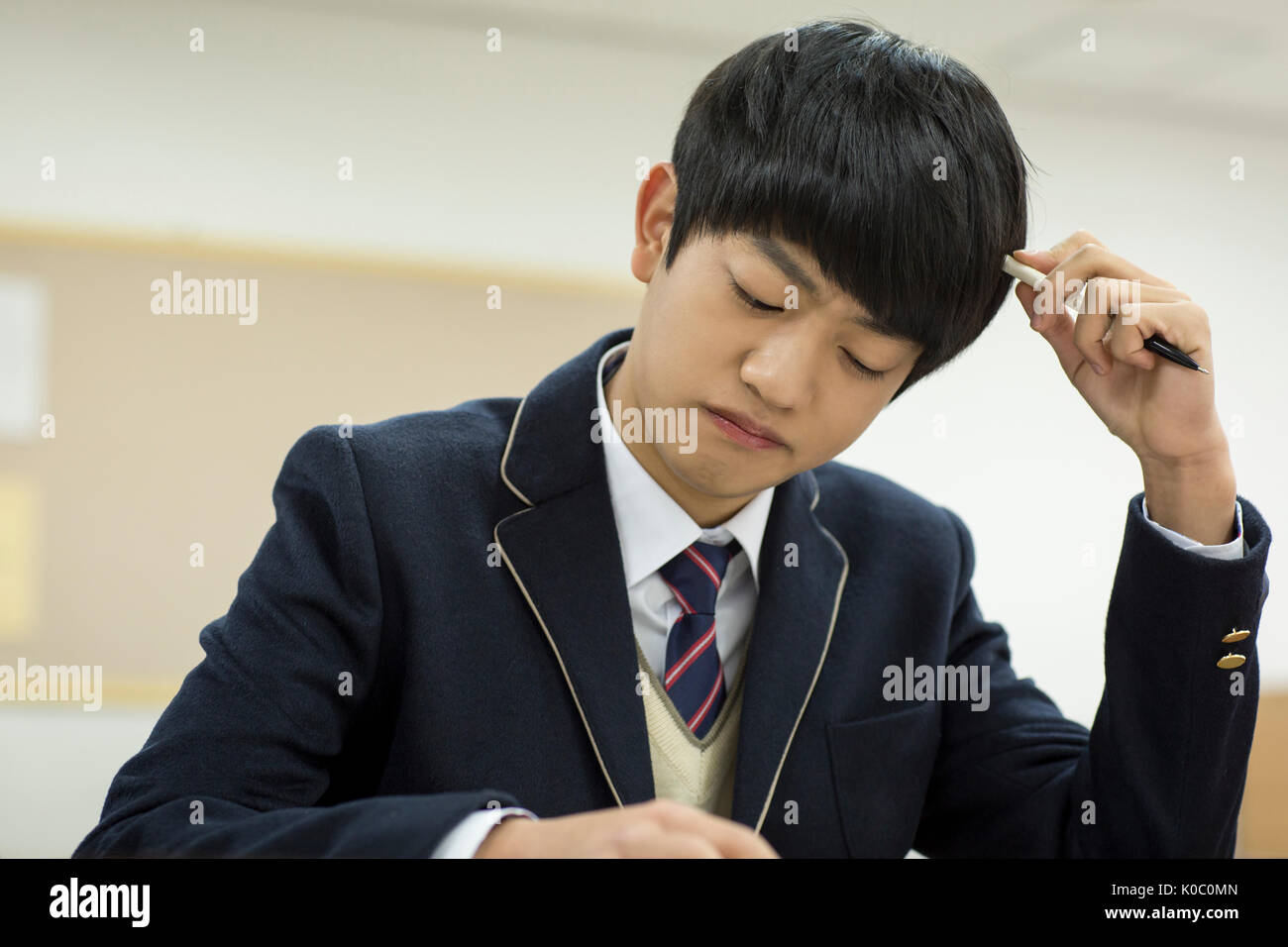 Portrait of school boy taking exam frowning face Stock Photo - Alamy