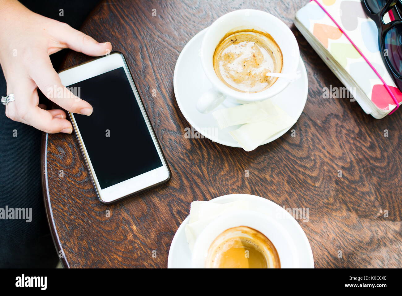 Girl using phone in a coffee bar Stock Photo - Alamy