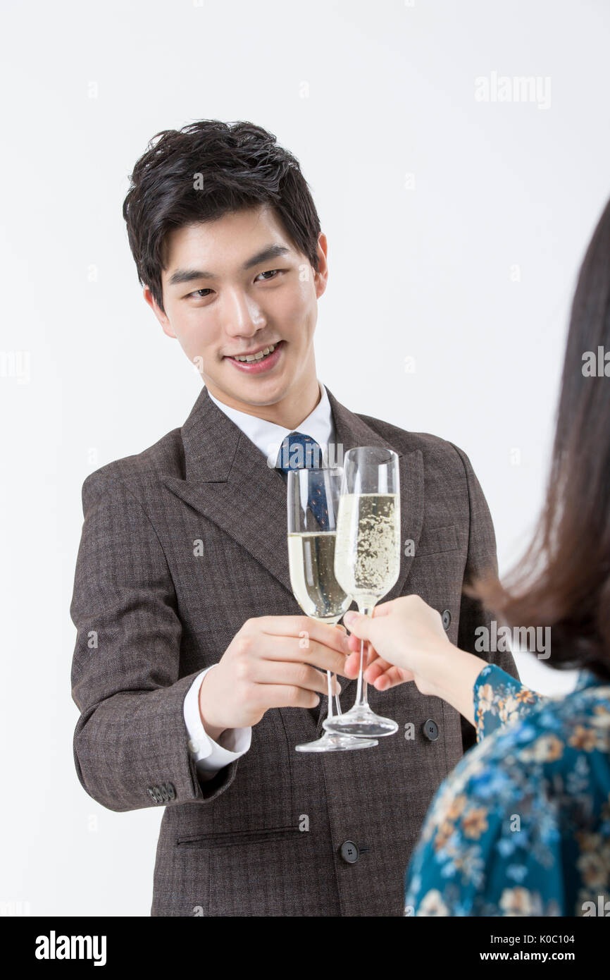 Young smiling businessman in suit toasting with champagne at party ...