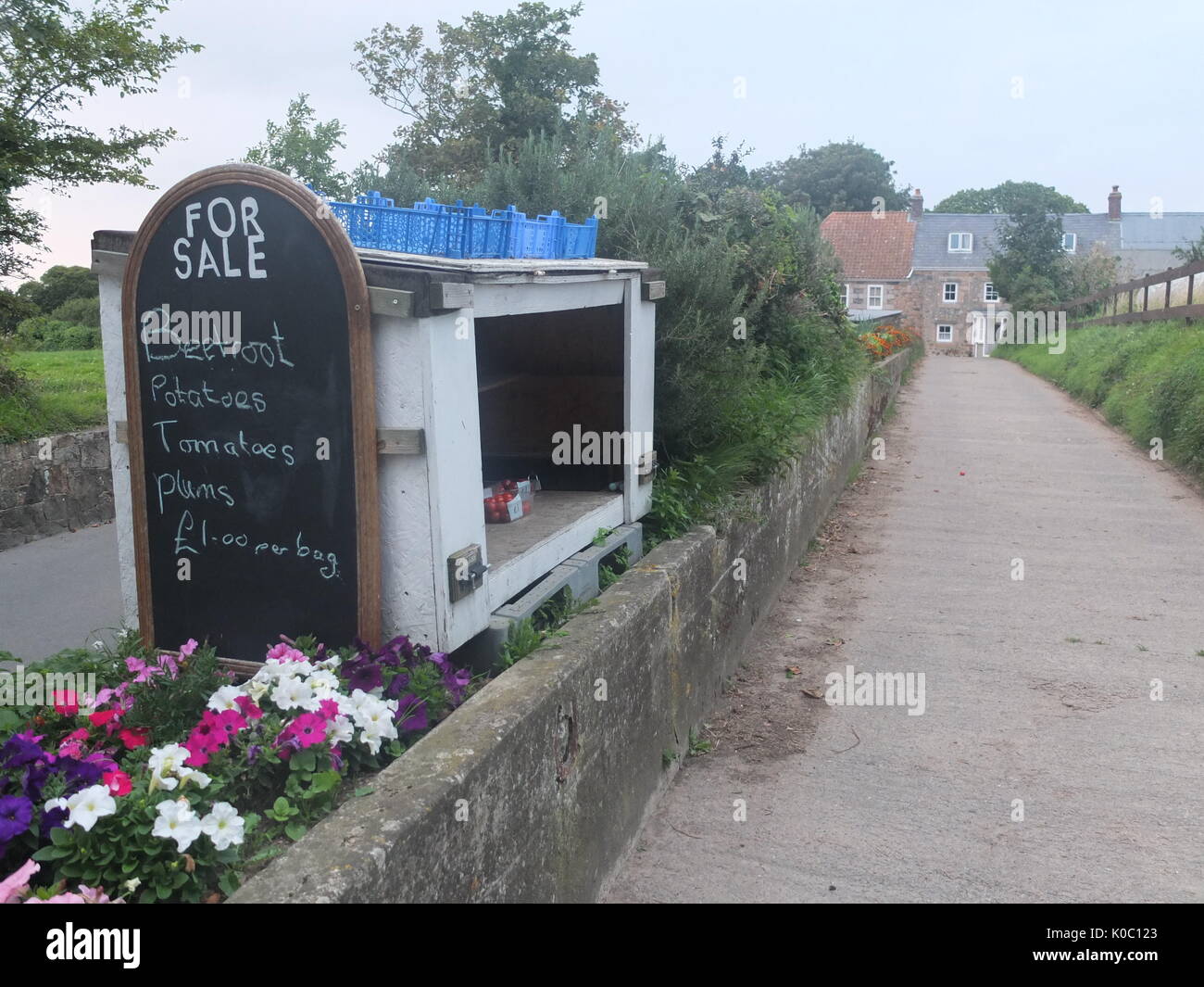 Honesty stall selling beetroot, potatoes, tomatoes and plums at a farm ...