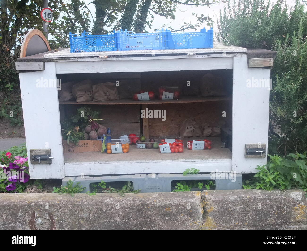 Honesty stall selling beetroot, potatoes, tomatoes and plums at a farm ...