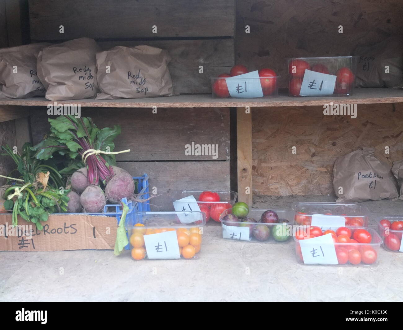 Honesty stall selling beetroot, potatoes, tomatoes and plums at a farm ...