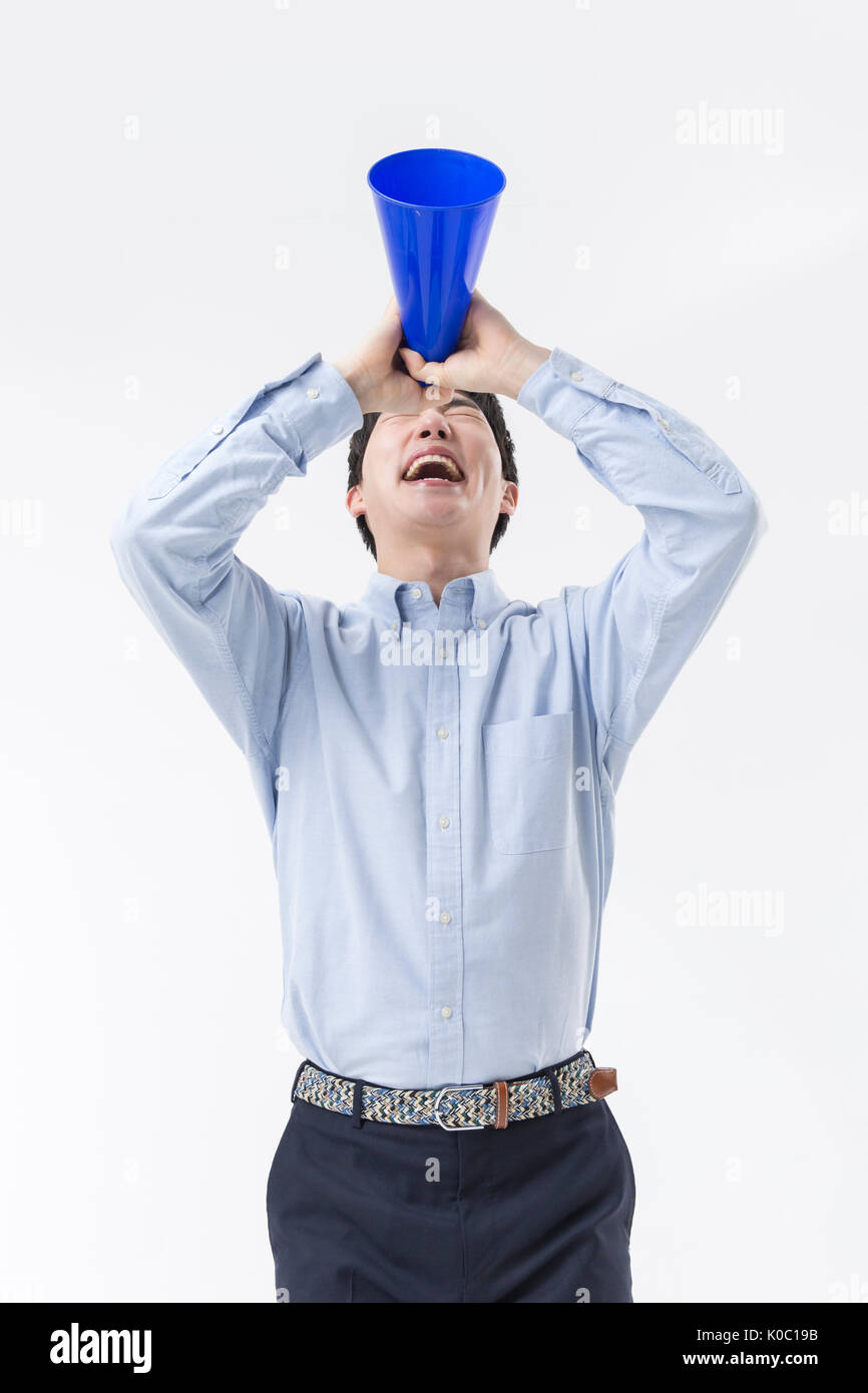 Young man shouting through a megaphone looking up Stock Photo - Alamy