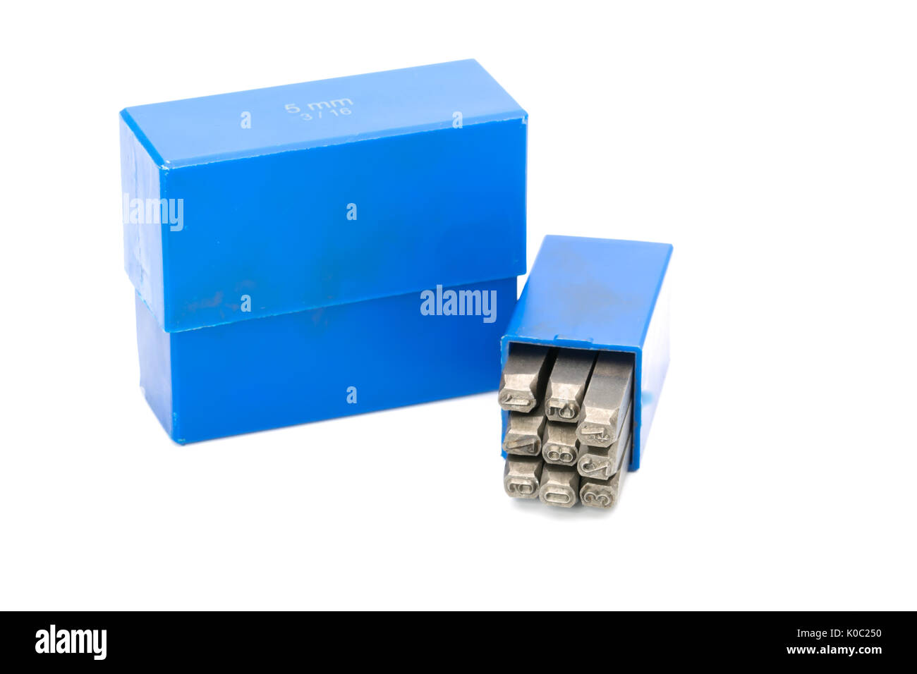 Set of metal stamp number punch in blue plastic box isolated on white ...