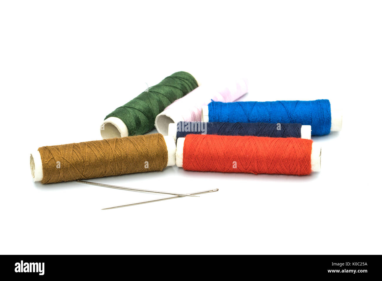 Two needles and six colorful core threads on white background Stock ...