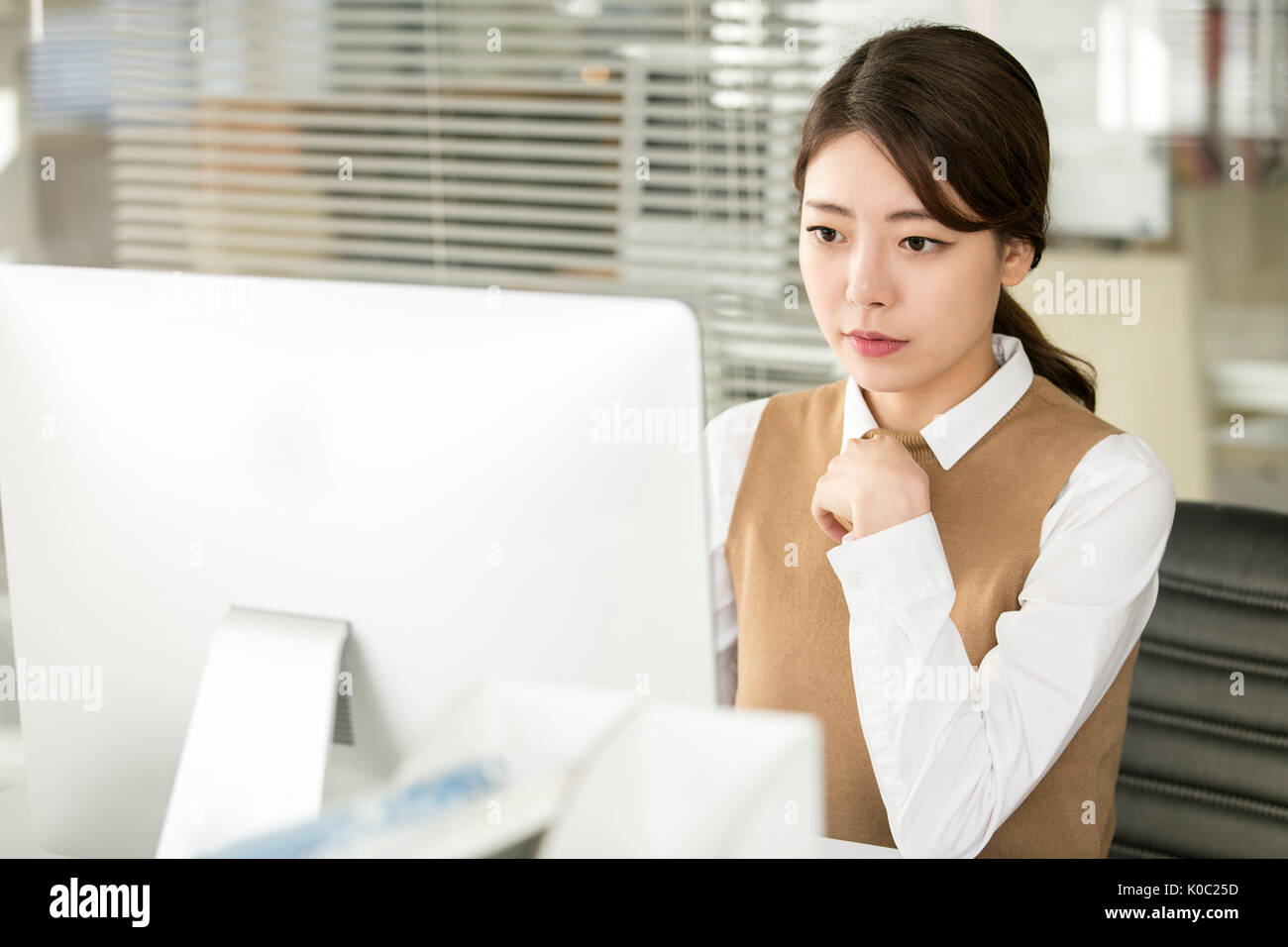 Portrait of young businesswoman worried watching computer monitor Stock ...