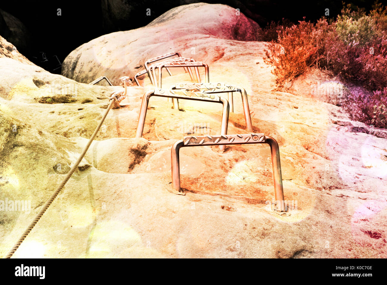 Film grain effect. Climbers ladder. Iron twisted rope fixed in block by ...