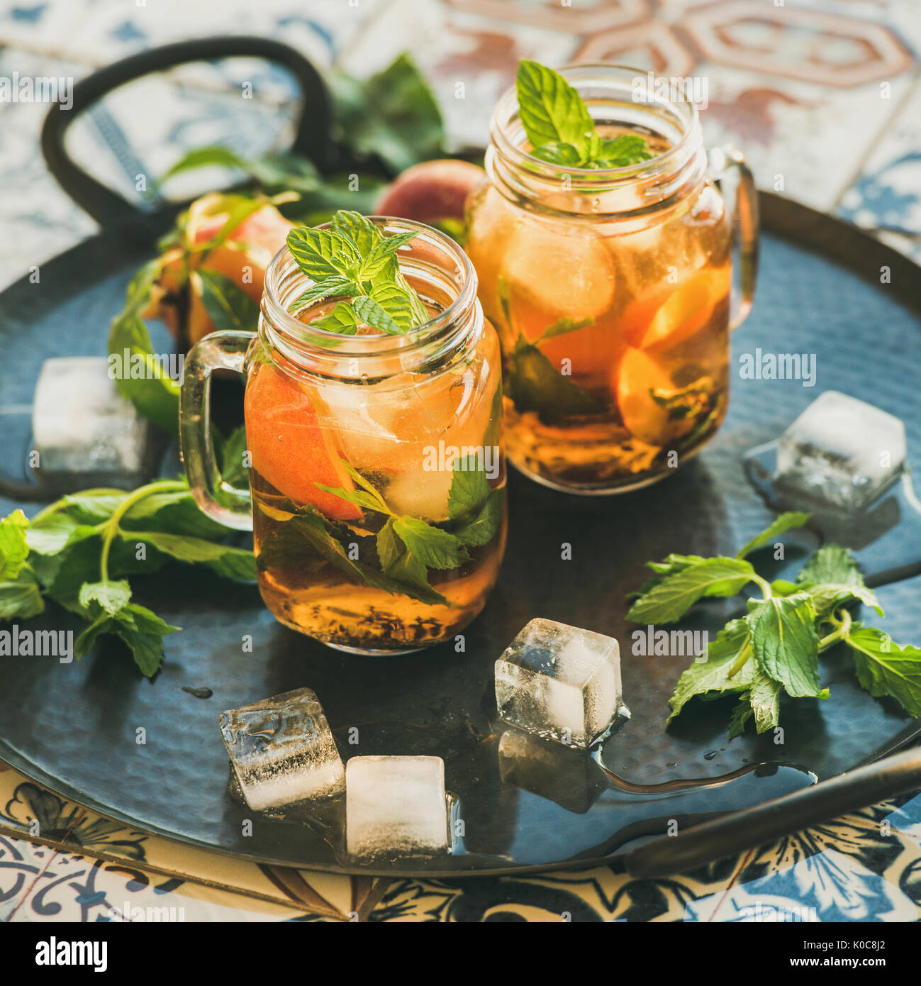 Summer refreshing cold peach ice tea with mint, square crop Stock Photo ...
