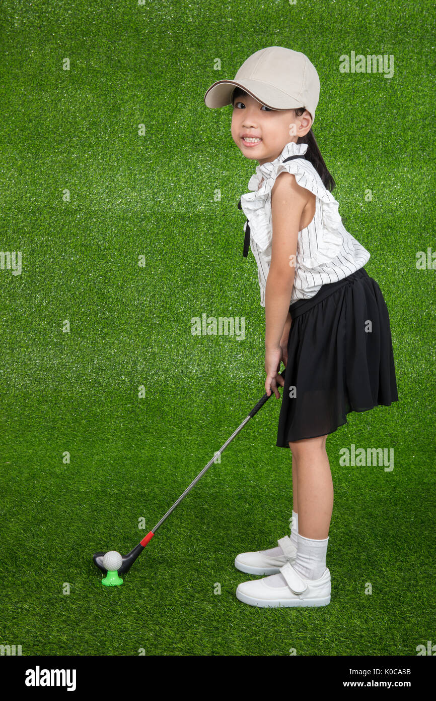 Asian Chinese little girl playing golf on green grass Stock Photo - Alamy