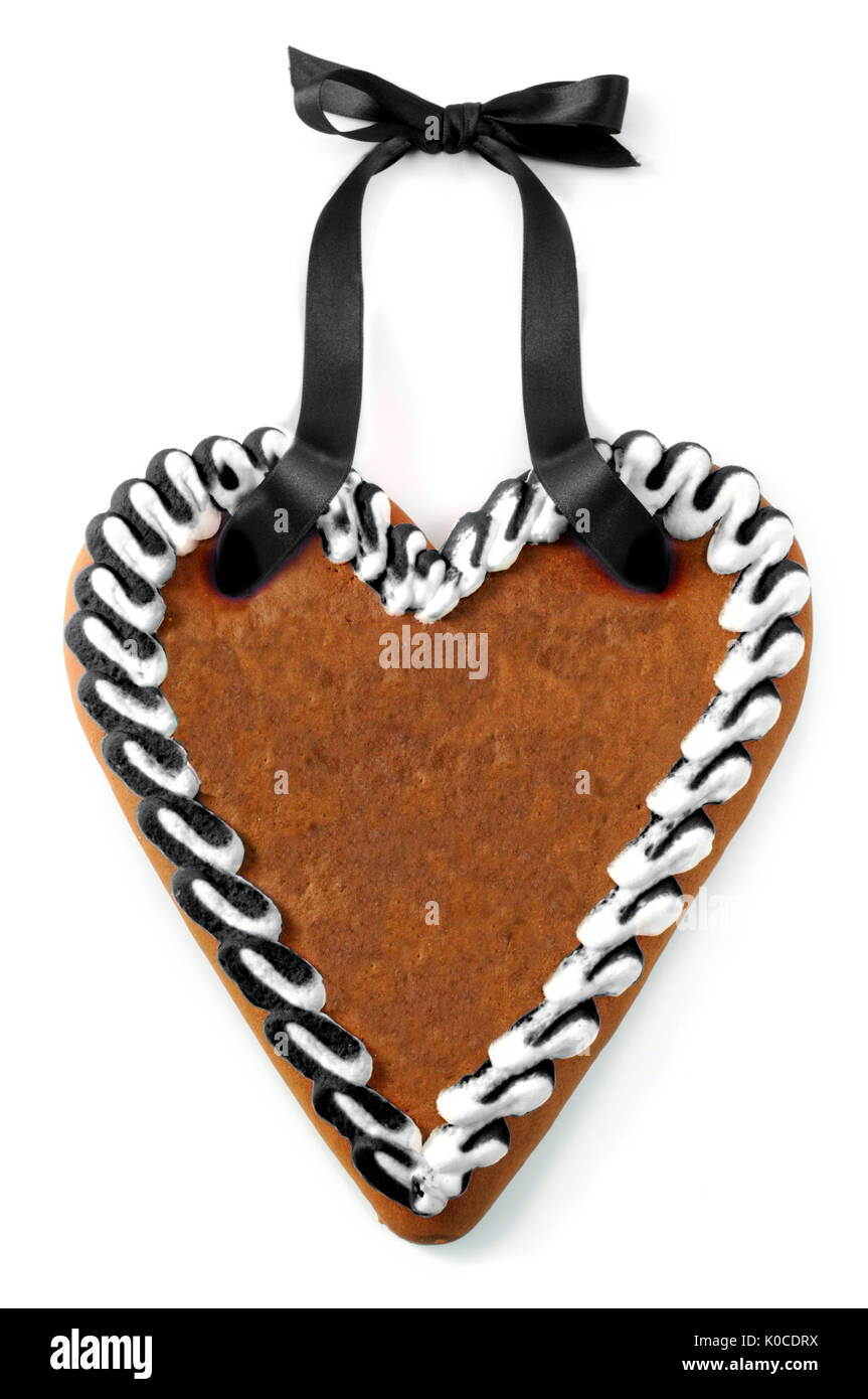 black gingerbread heart cookie on white isolated background with copy ...