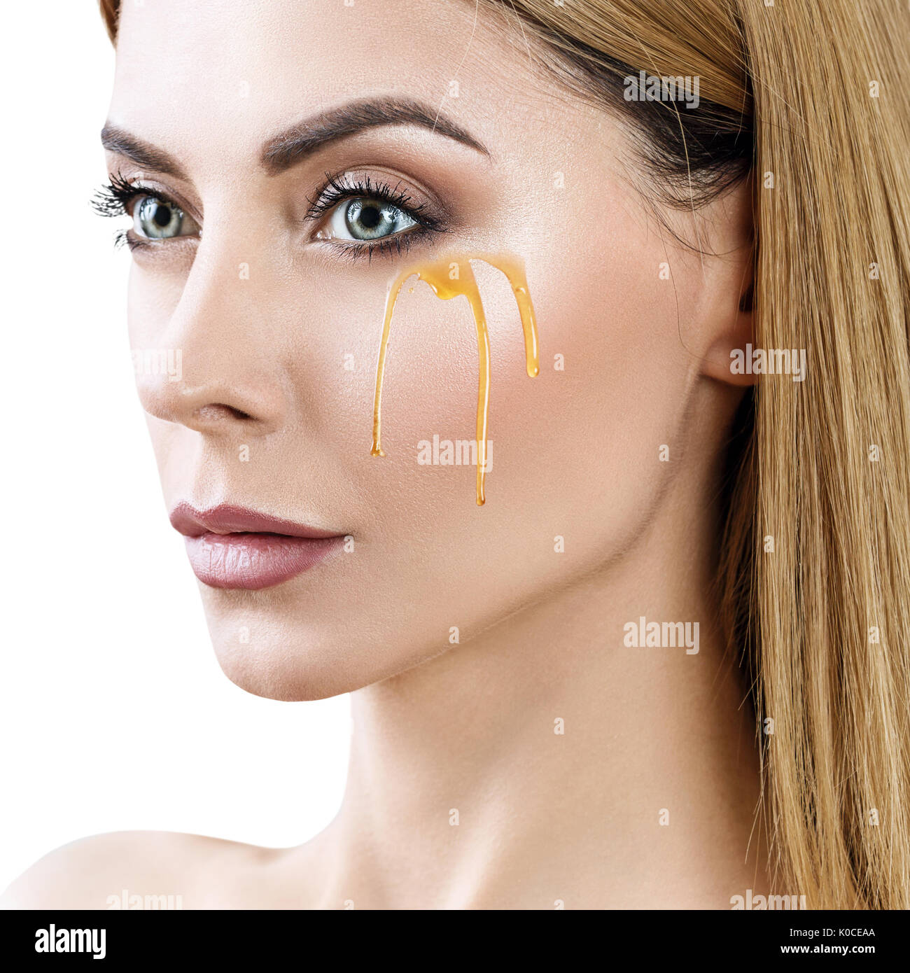 Beautiful woman with honey on face Stock Photo - Alamy