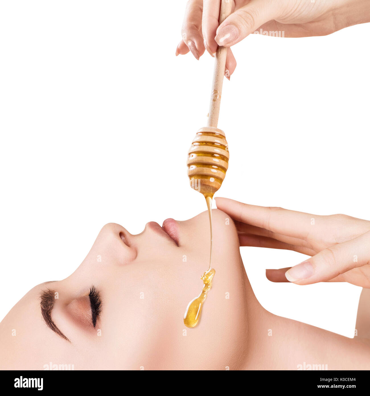Beautiful woman with honey on face Stock Photo - Alamy