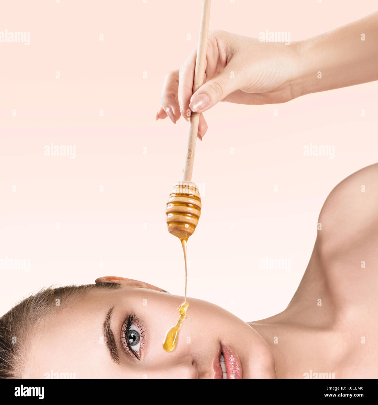 Beautiful woman with honey on face Stock Photo - Alamy