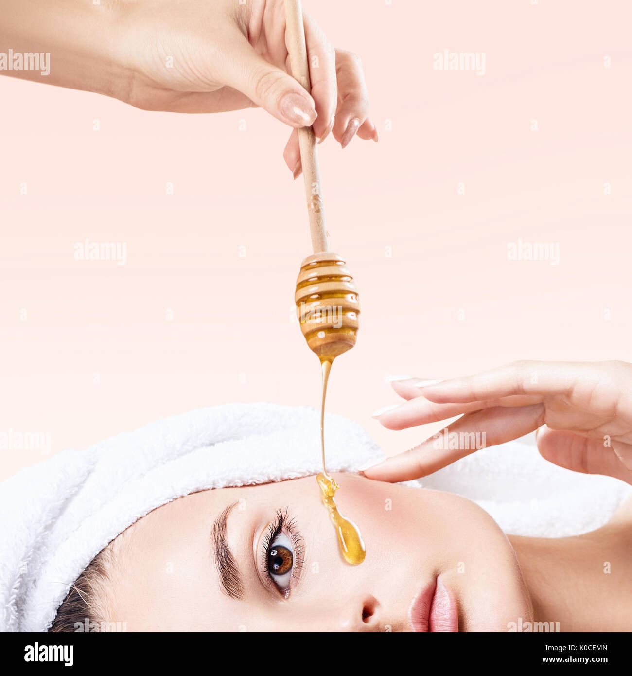 Beautiful woman with honey on face Stock Photo - Alamy