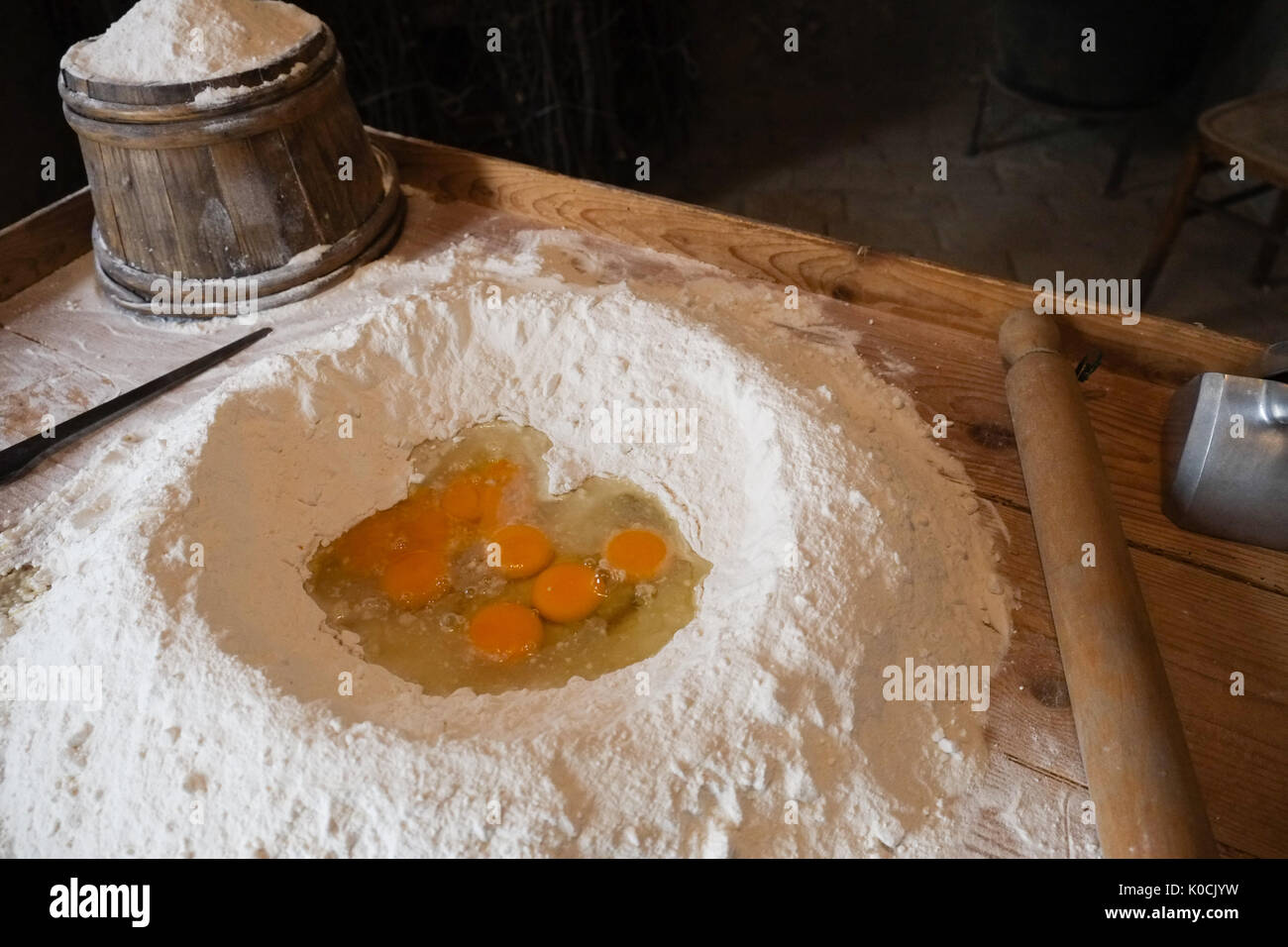 Italian old kitchen pasta preparation with raw ingredients. Eggs and ...