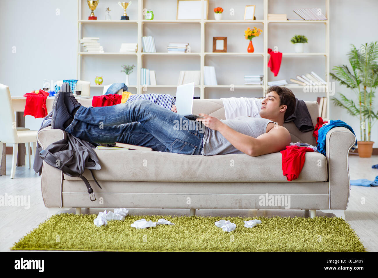 Young man working studying in messy room Stock Photo - Alamy