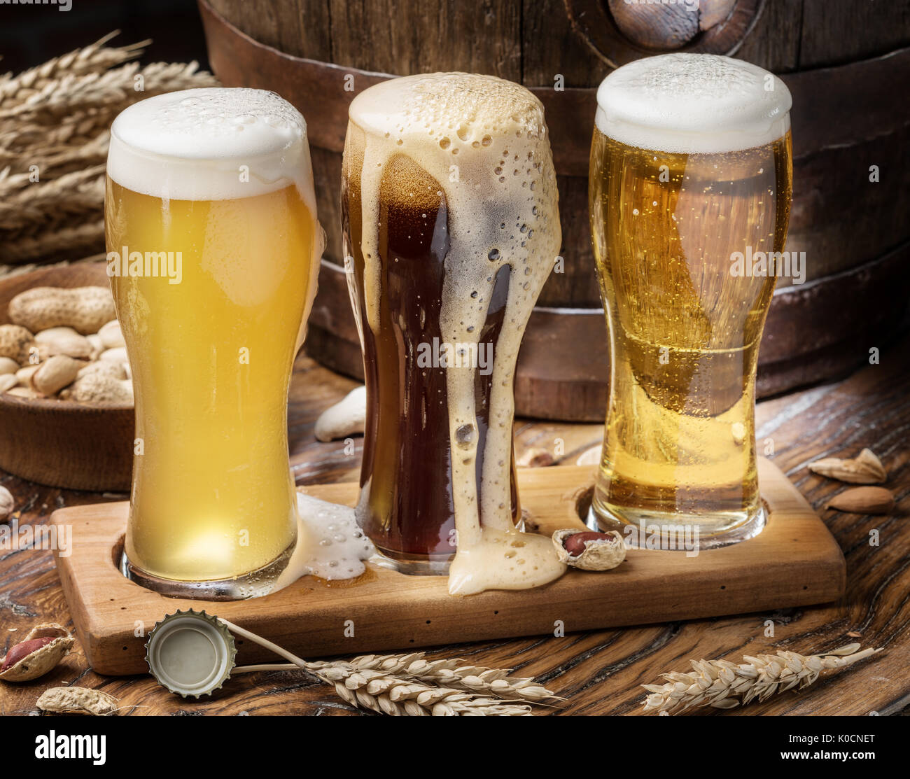 Glasses of beer and snacks on the wooden table. Front view Stock Photo ...