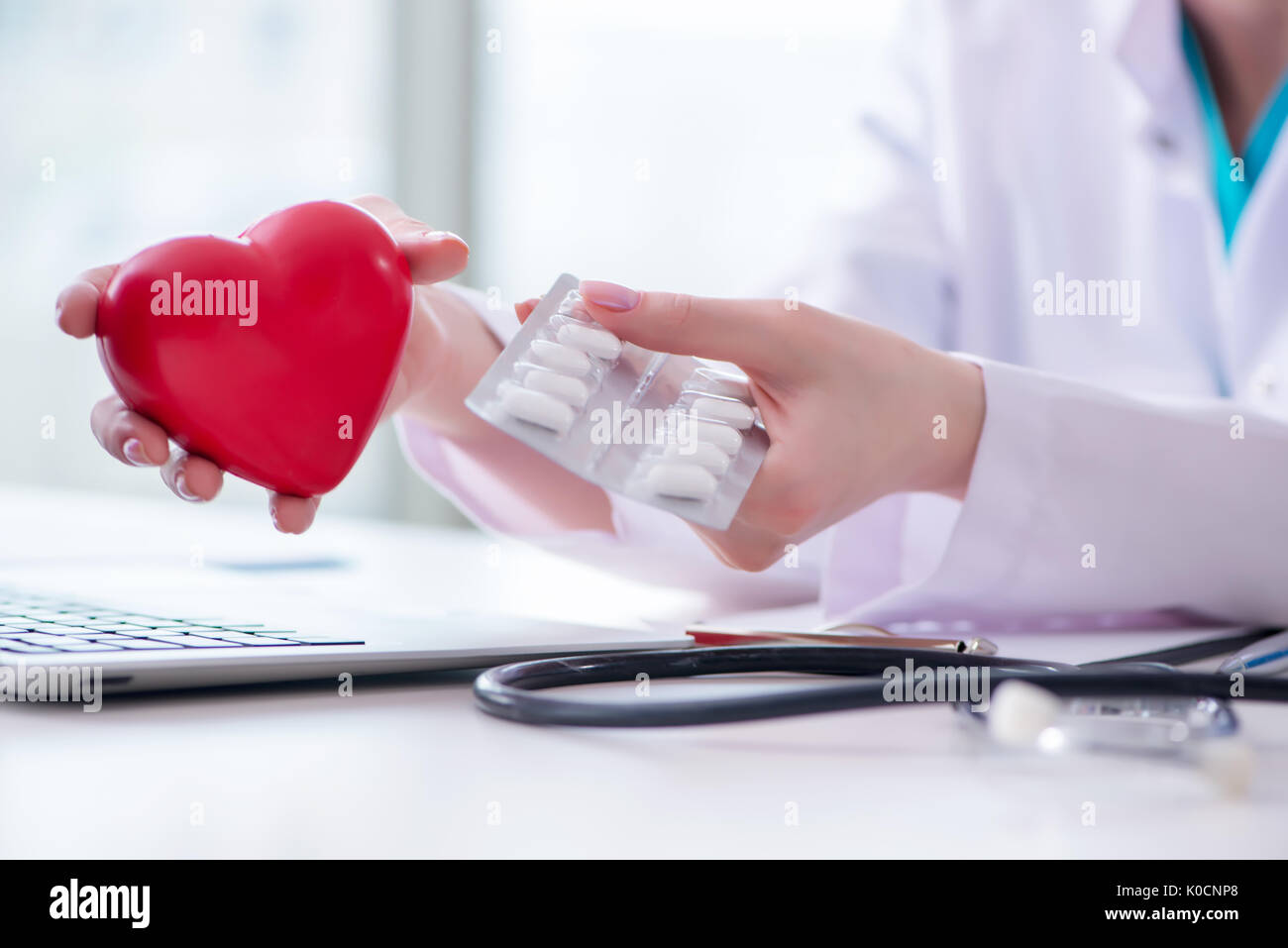 Doctor checking up heart in medical concept Stock Photo - Alamy