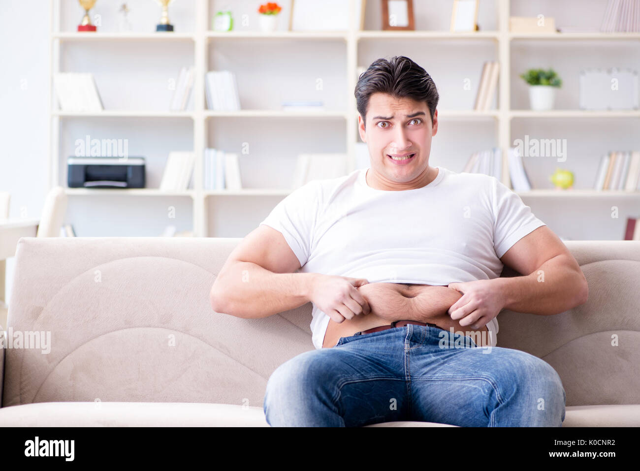 Man suffering from extra weight in diet concept Stock Photo - Alamy