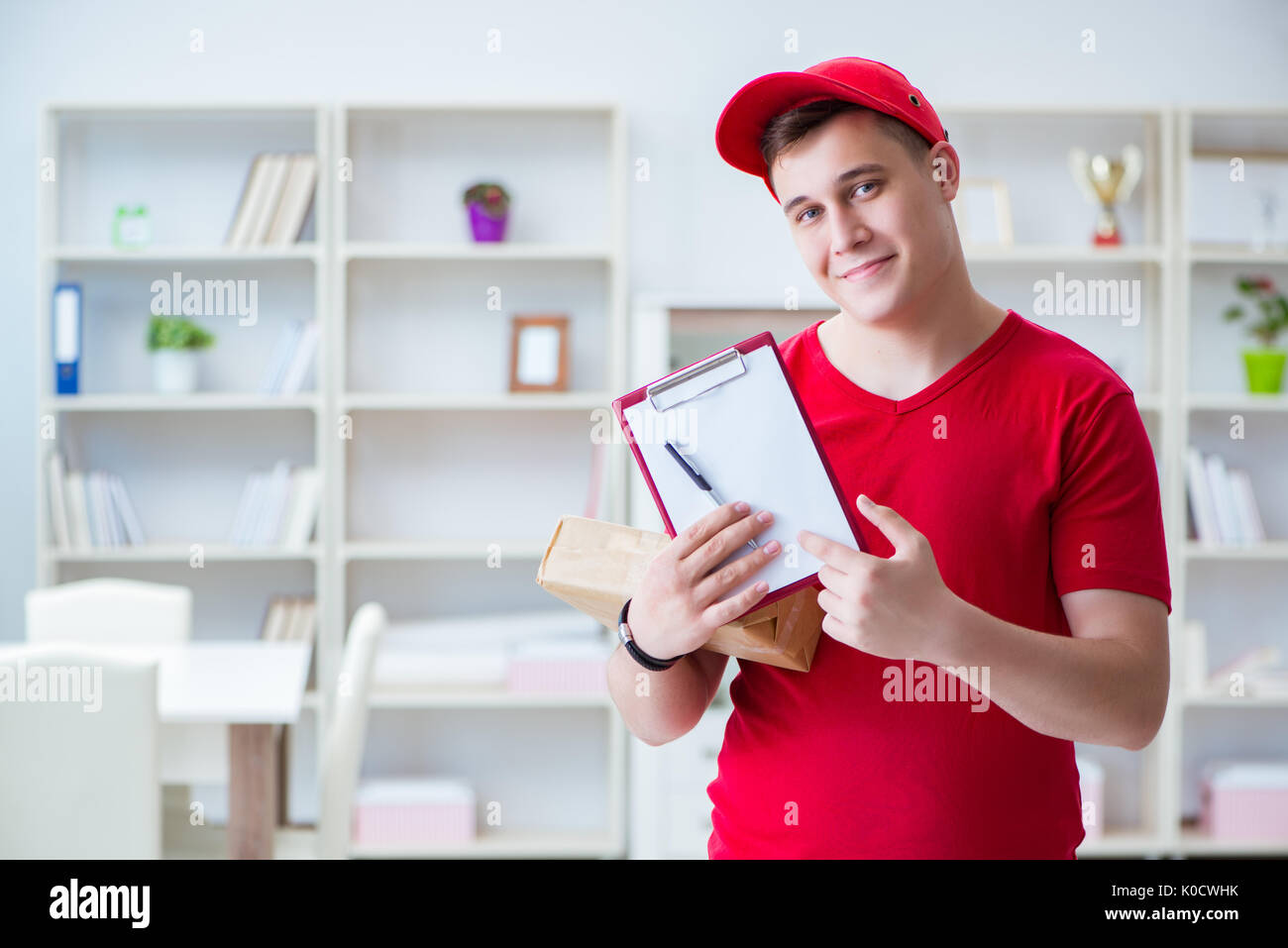 Post man delivering a parcel package Stock Photo - Alamy