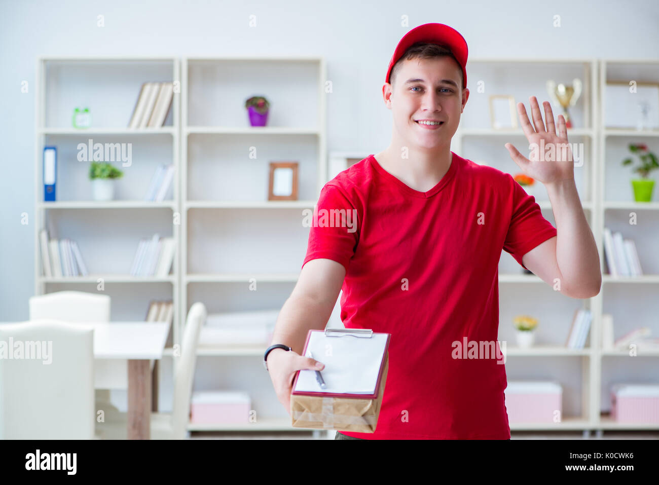 Post man delivering a parcel package Stock Photo - Alamy