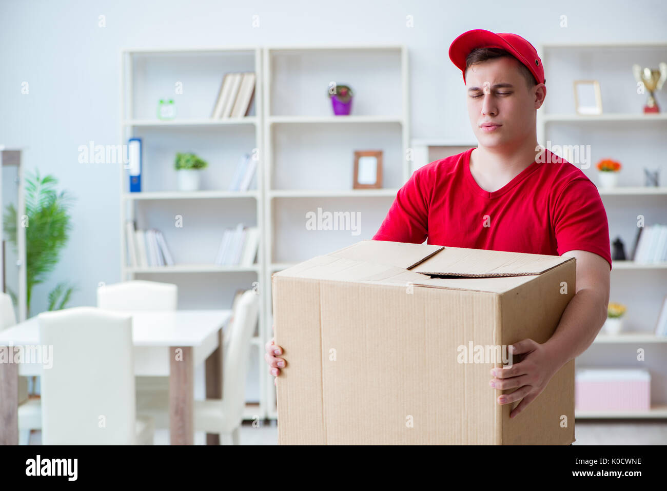 Post man delivering a parcel package Stock Photo - Alamy