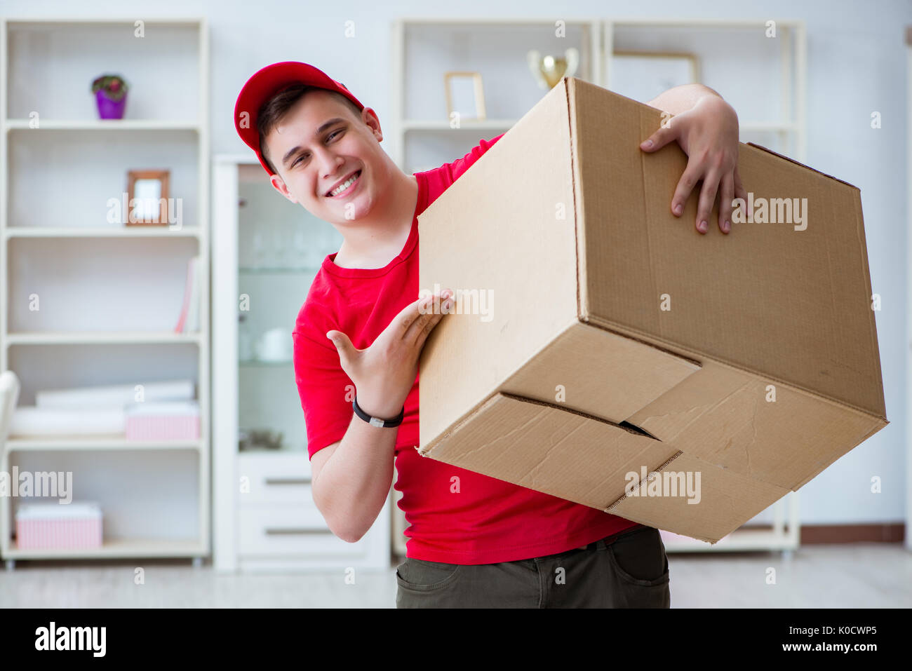 Post man delivering a parcel package Stock Photo - Alamy