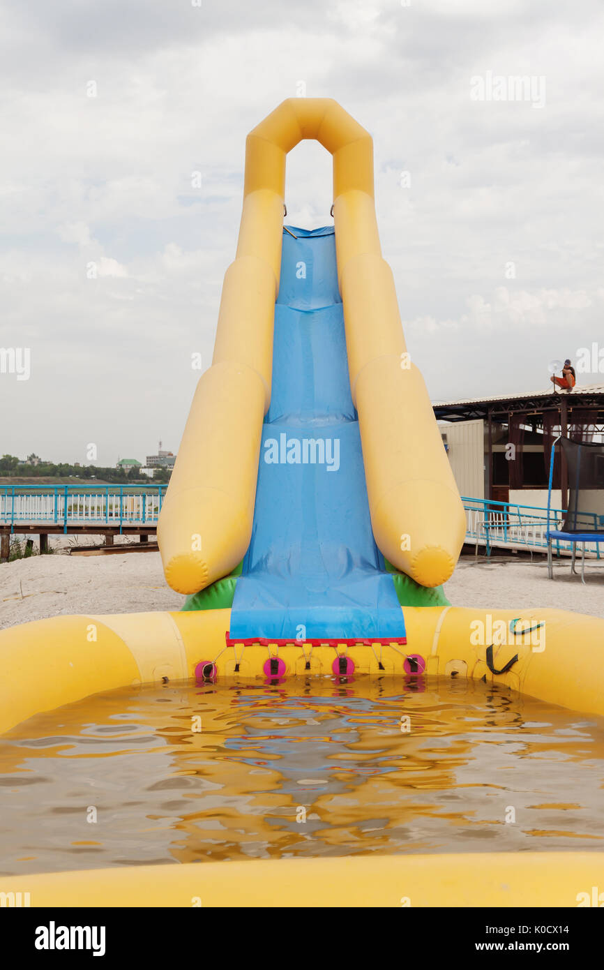 Inflatable water slide on the beach in summer Stock Photo - Alamy