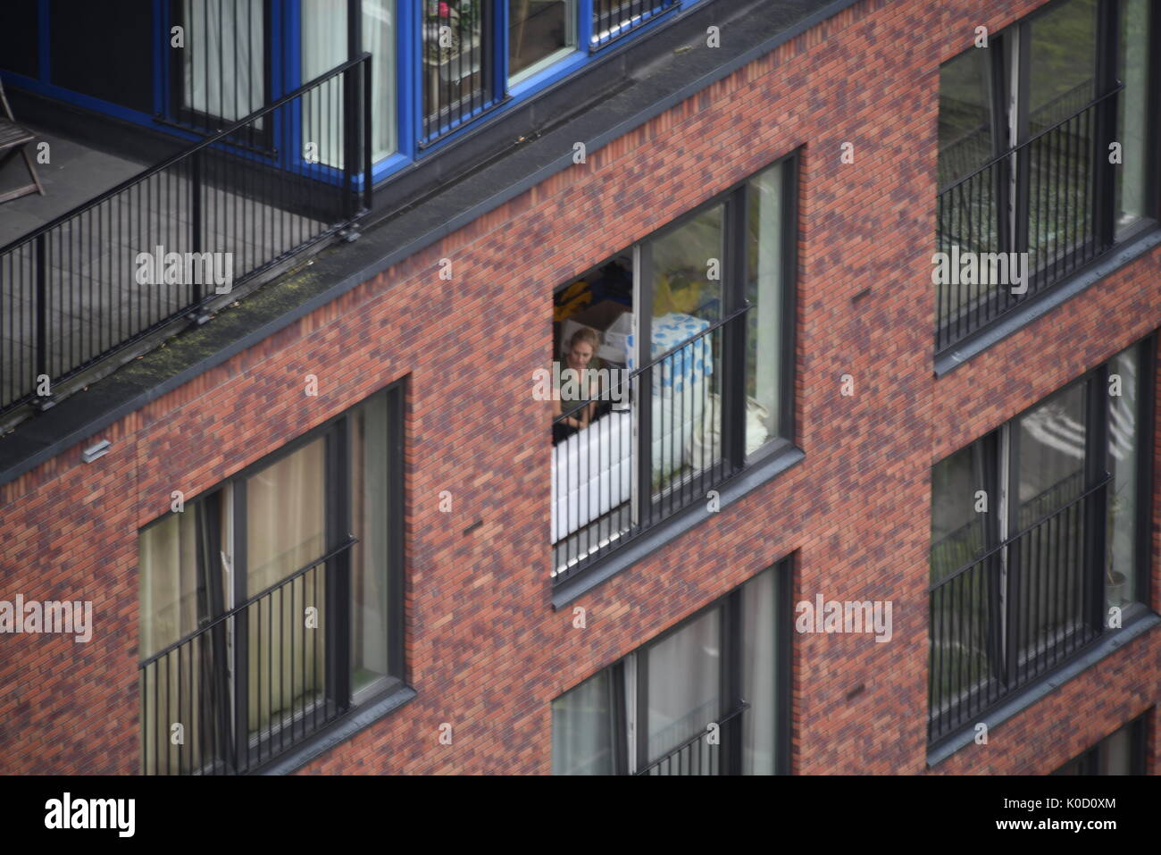 Europaplein Utrecht - Couple looking through their window Stock Photo ...