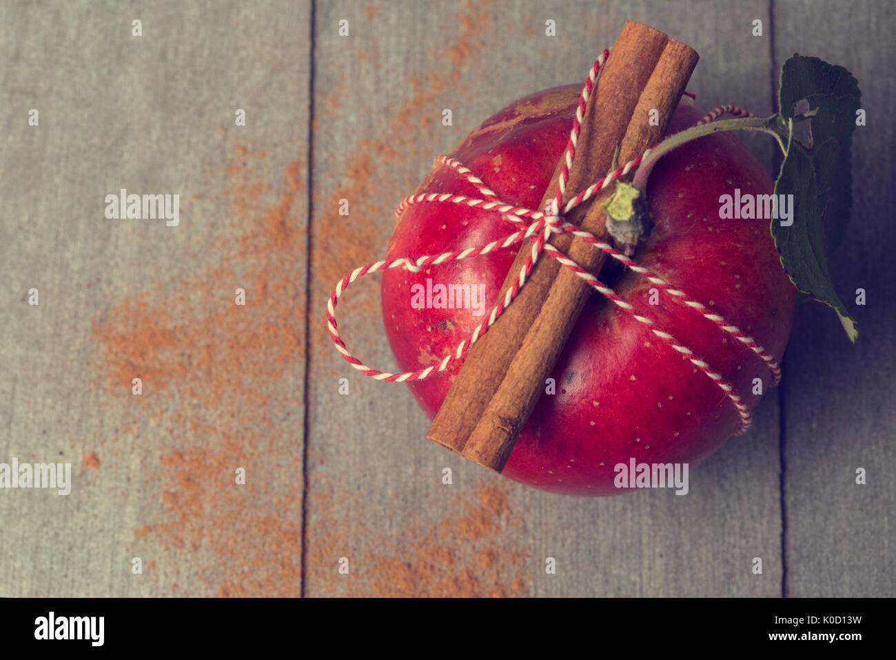 Fresh red apple with cinnamon sticks and ground cinnamon. Concept for ...