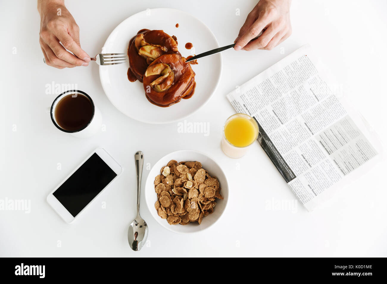 Cropped picture top view of handsome man eating pastries Stock Photo ...