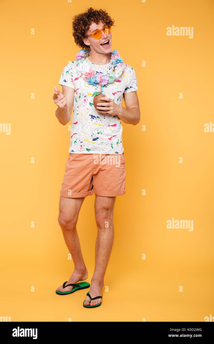 Full length portrait of a happy excited man in summer clothes standing ...